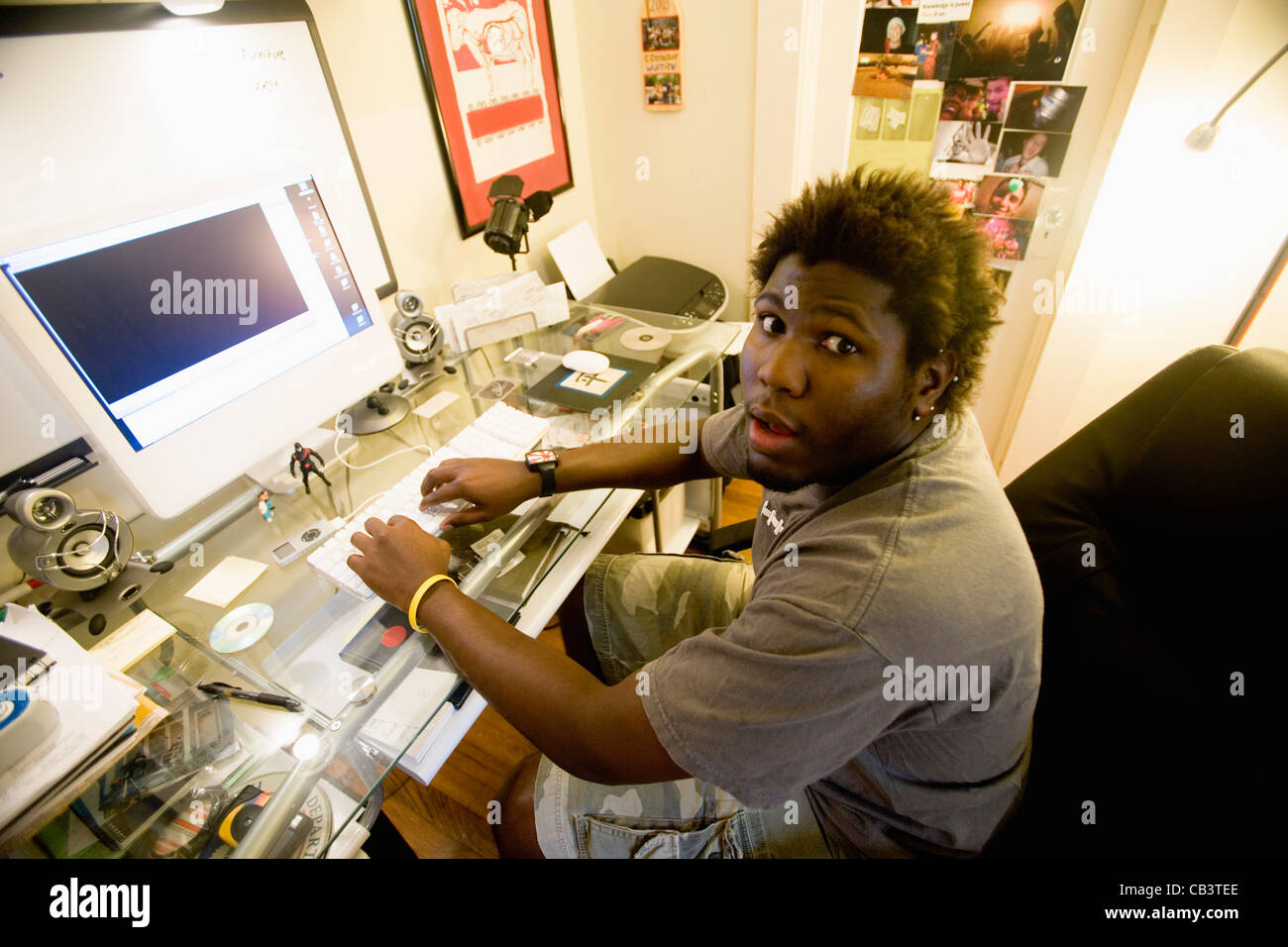 Young man sitting messy desk hi-res stock photography and images - Alamy