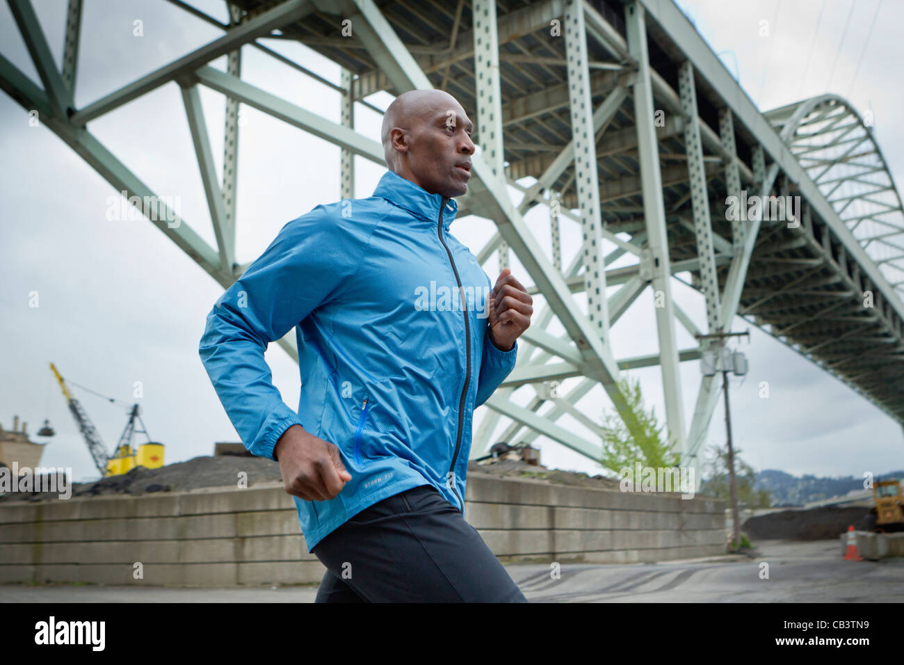 Man running underneath bridge Stock Photo - Alamy