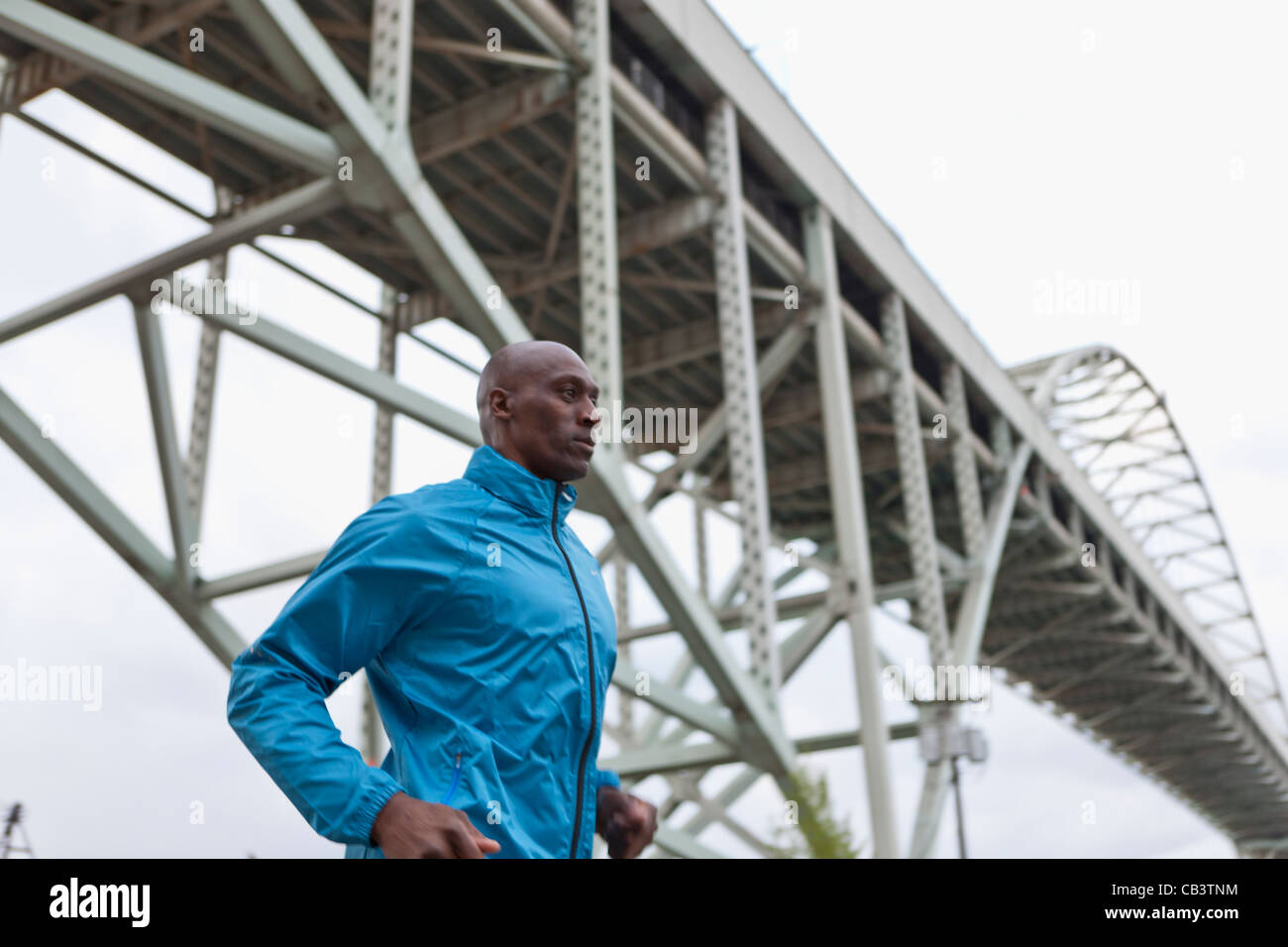 Man running underneath bridge Stock Photo - Alamy