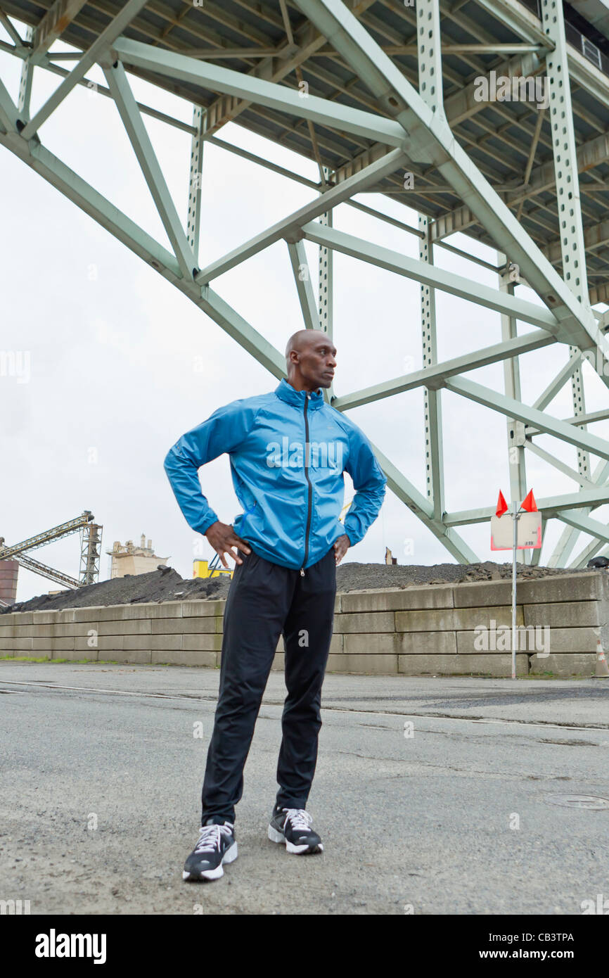 Man standing beneath bridge Stock Photo - Alamy