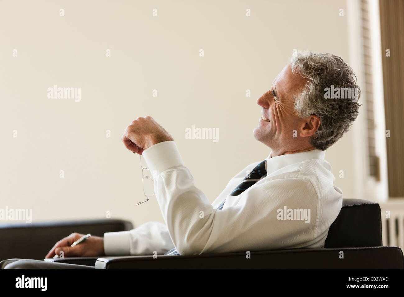 Businessman waiting in office lobby Stock Photo - Alamy