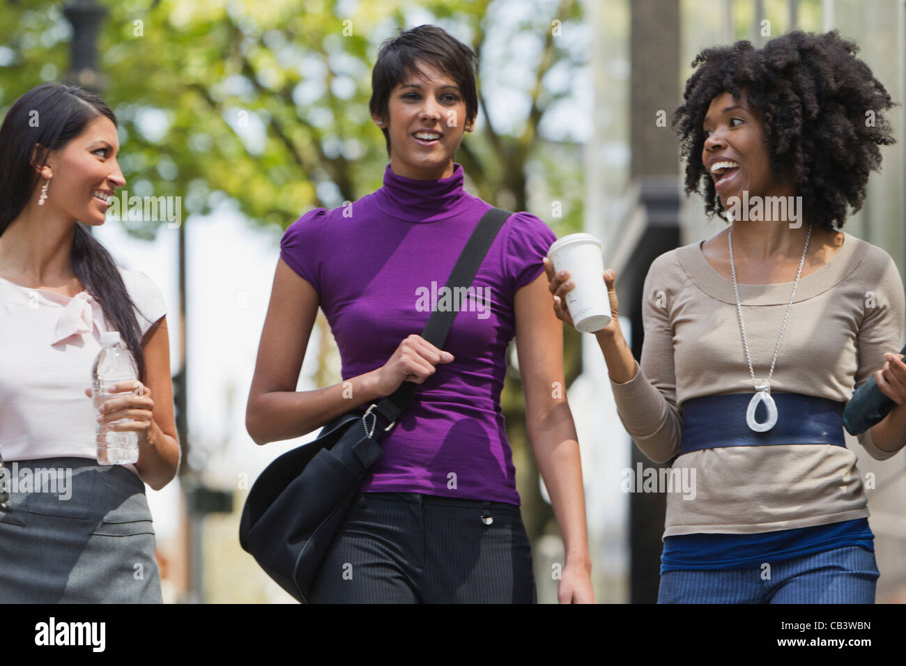 Three businesswomen walking in street downtown Stock Photo - Alamy
