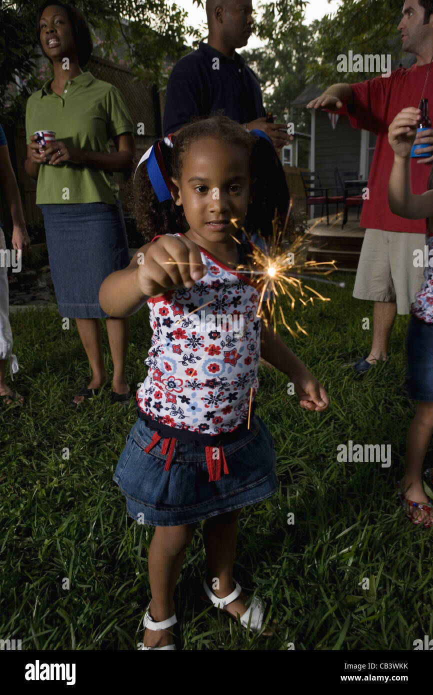 Little girl on 4th of July playing with sparkler Stock Photo - Alamy