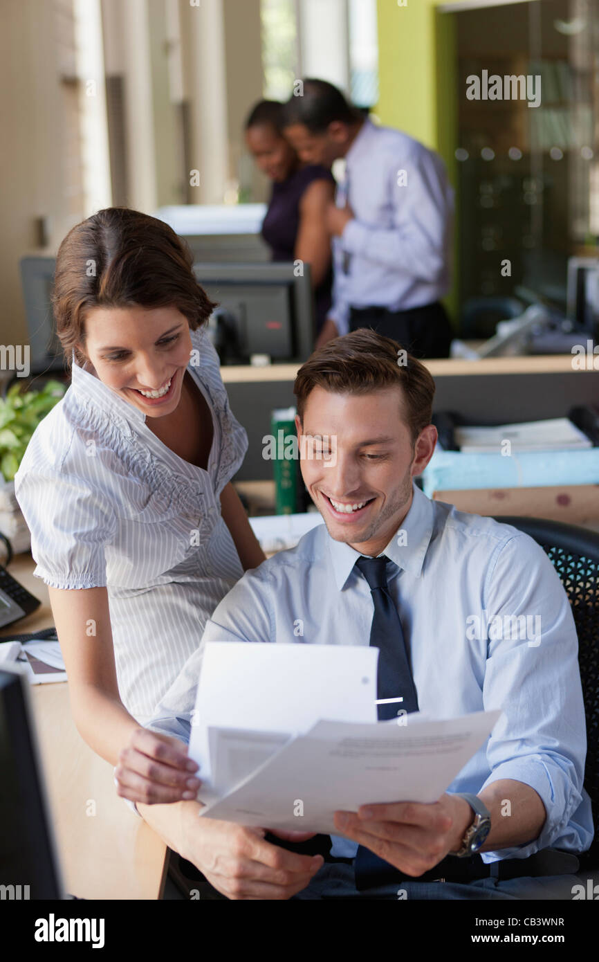 Employees collaborating in office Stock Photo - Alamy