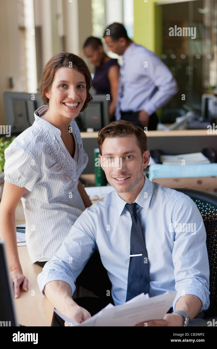 Employees at desk in office Stock Photo - Alamy