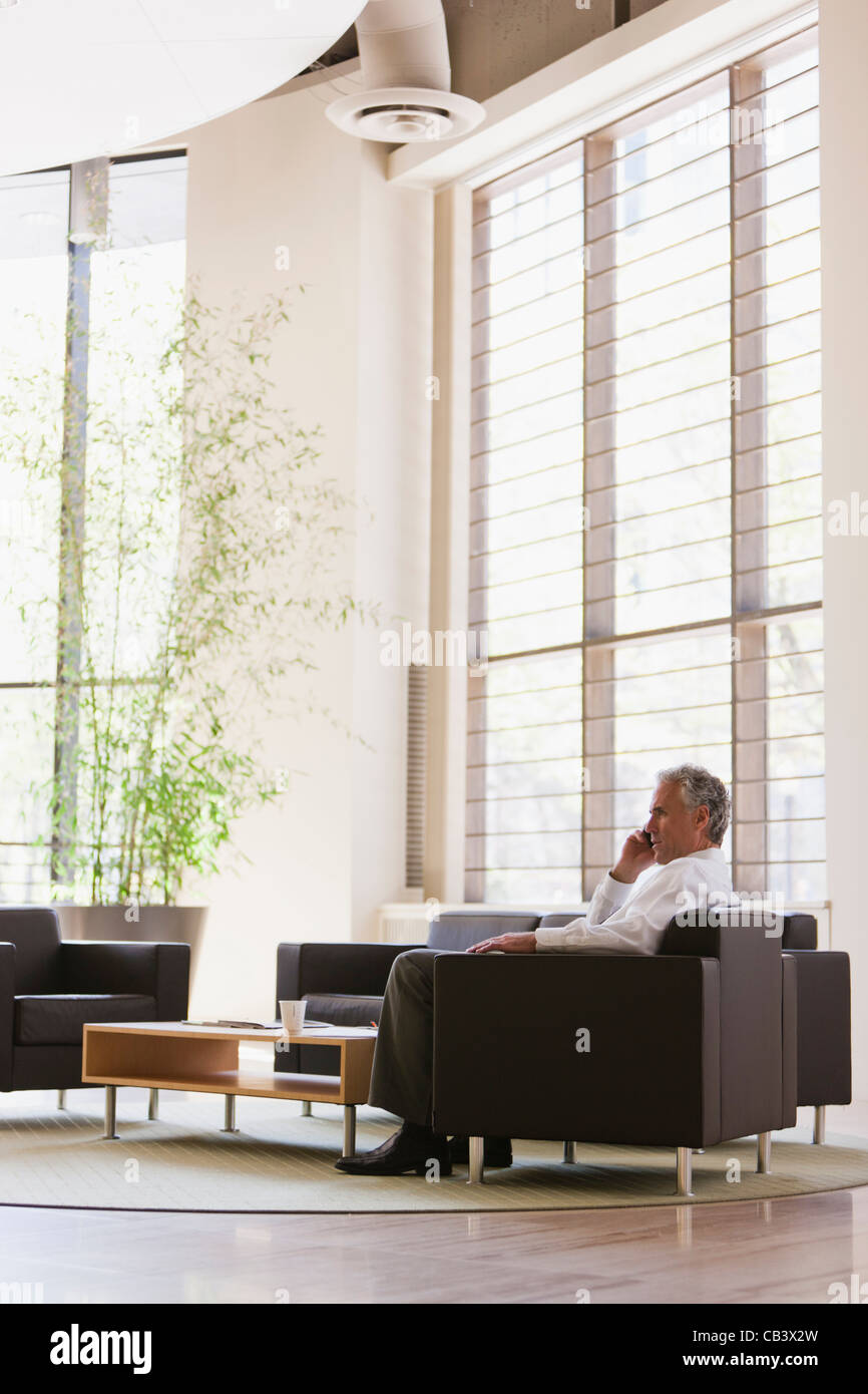 Business executive waiting in office lobby Stock Photo - Alamy