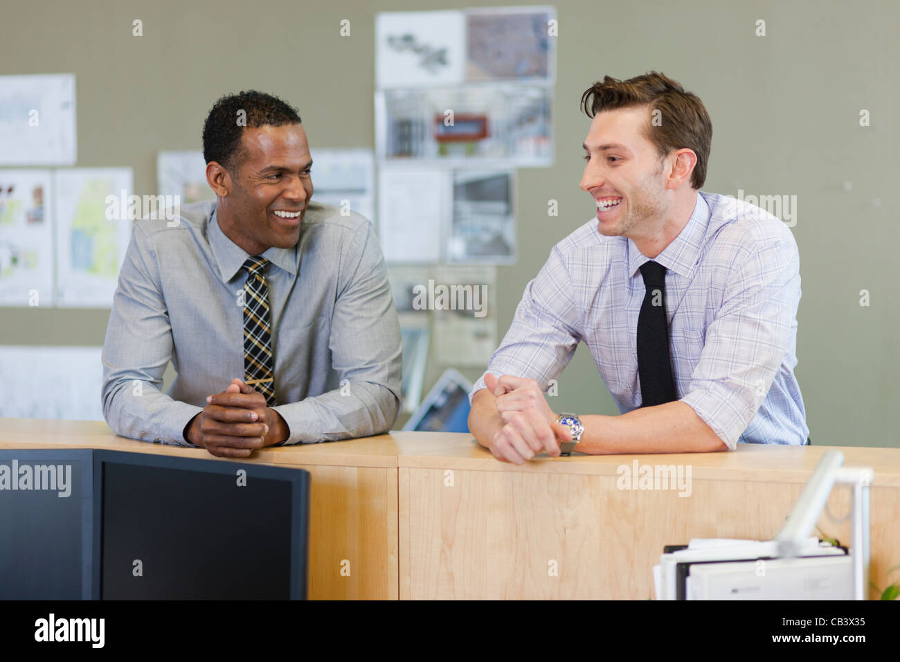 Male co-workers hanging out at office Stock Photo - Alamy
