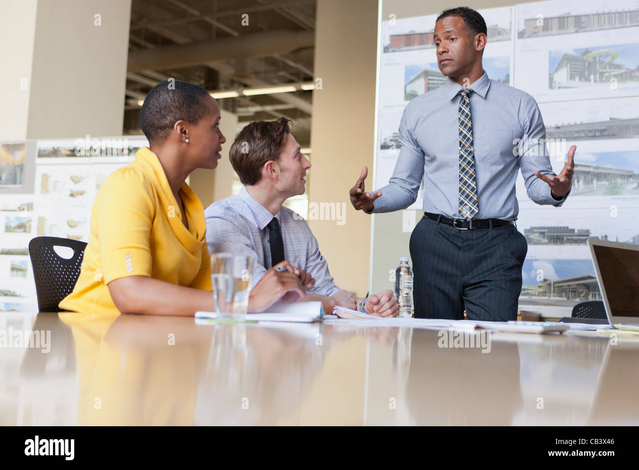 Workgroup collaborating on project at office Stock Photo - Alamy
