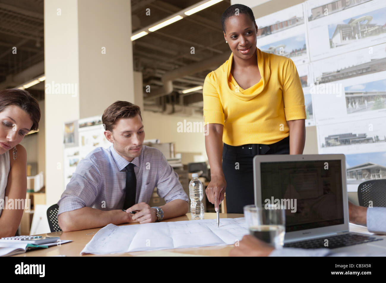 Group collaborating on project at office Stock Photo - Alamy