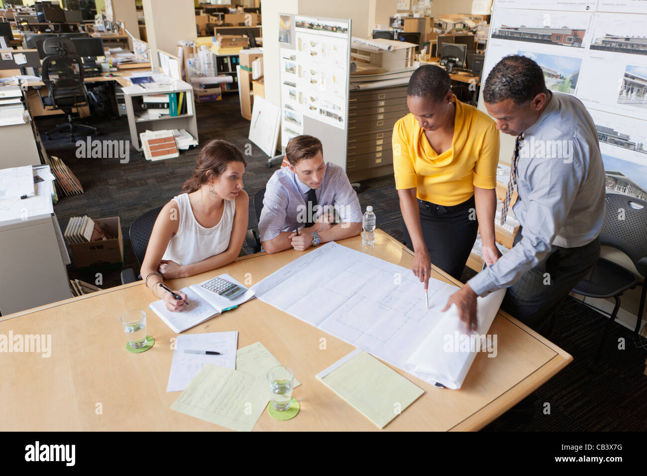 Group collaborating on project at office Stock Photo - Alamy