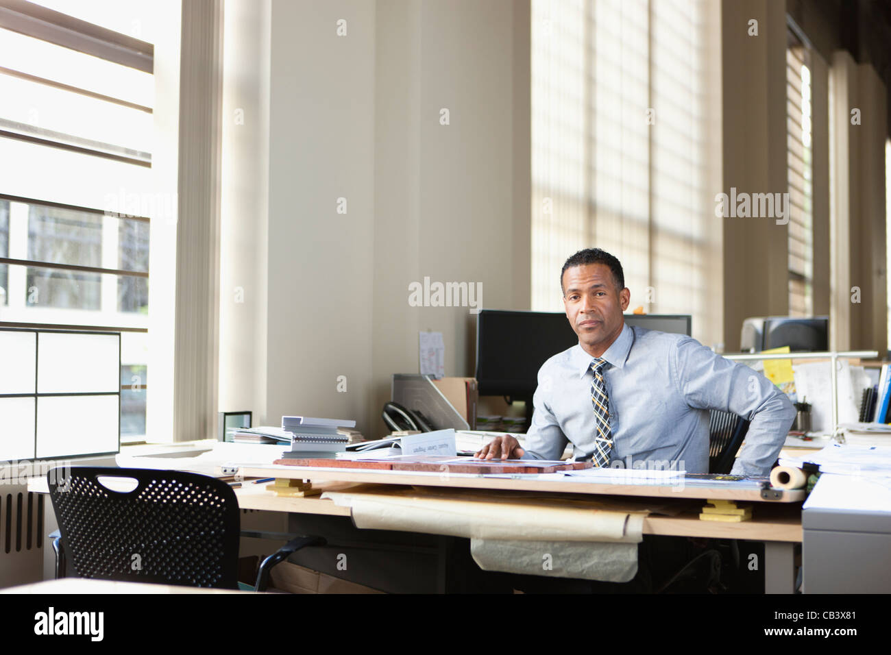 Businessman at desk in office Stock Photo - Alamy