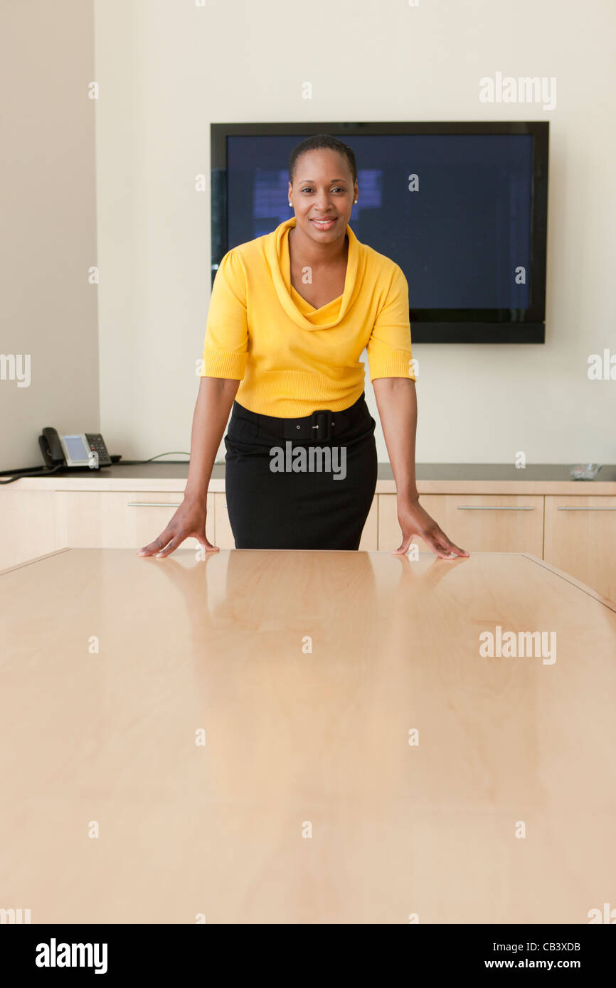 Businesswoman standing at conference table, portrait Stock Photo - Alamy
