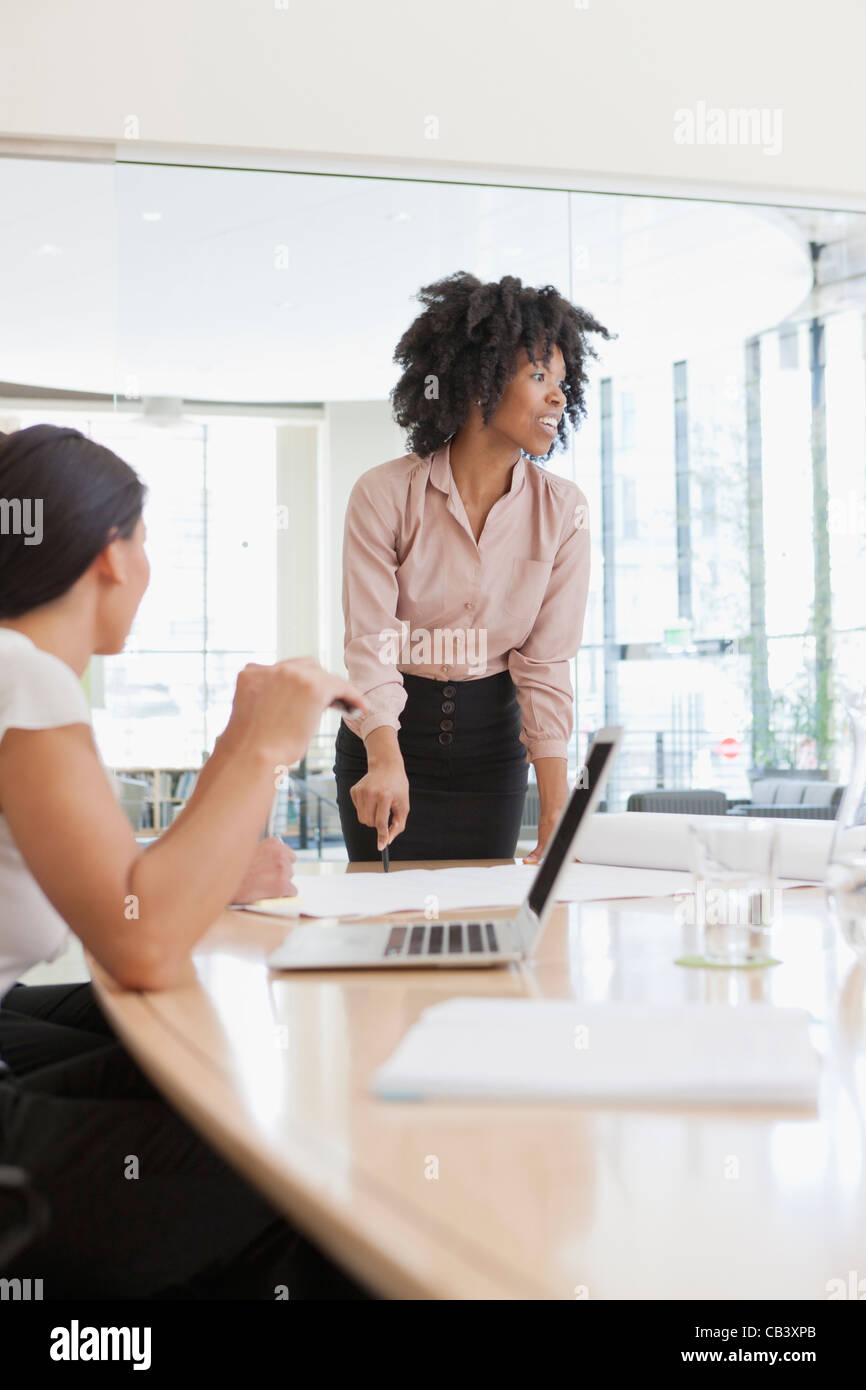 Project discussions amongst employees in boardroom Stock Photo - Alamy