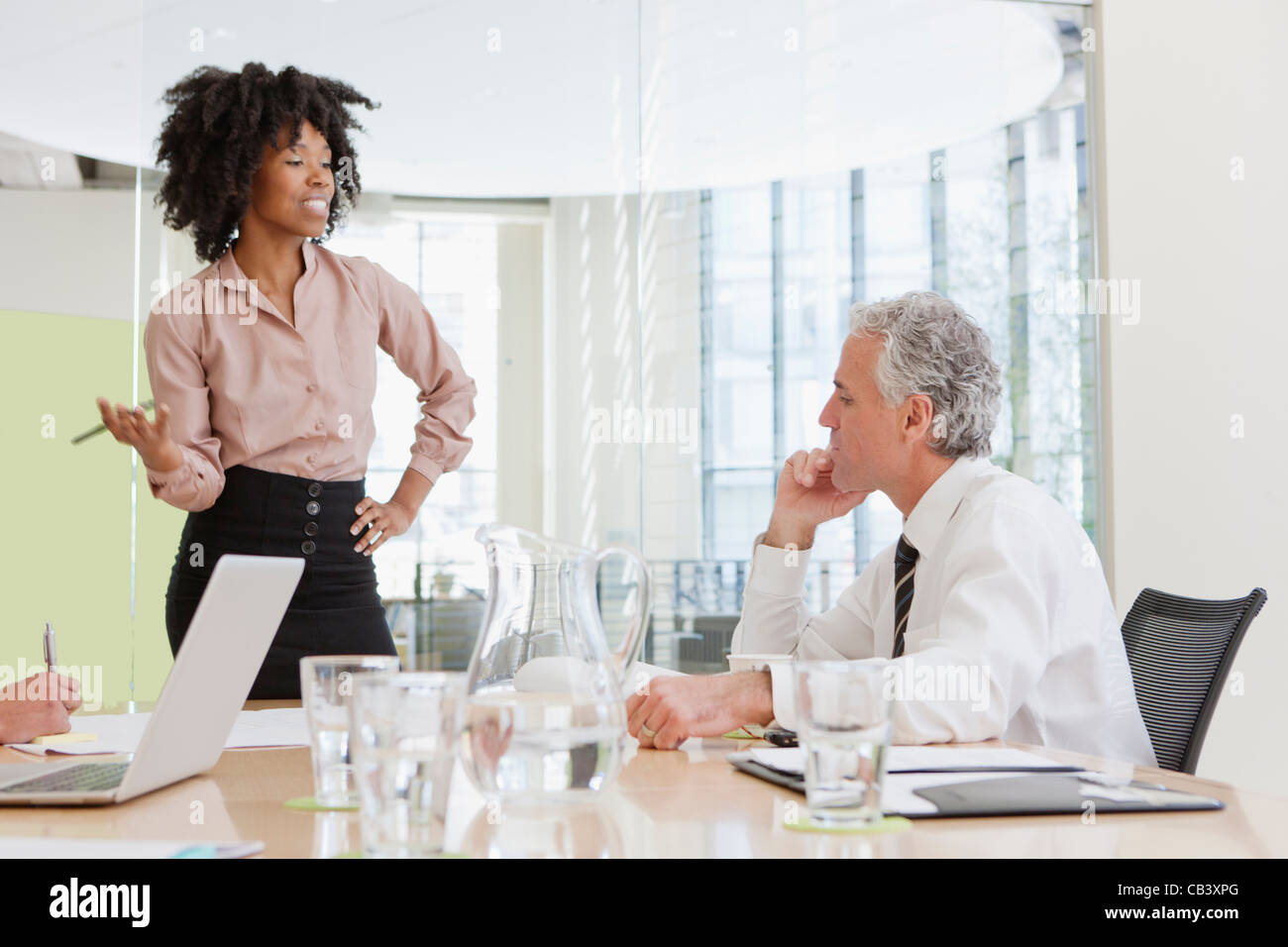 Project discussions amongst employees in boardroom Stock Photo - Alamy