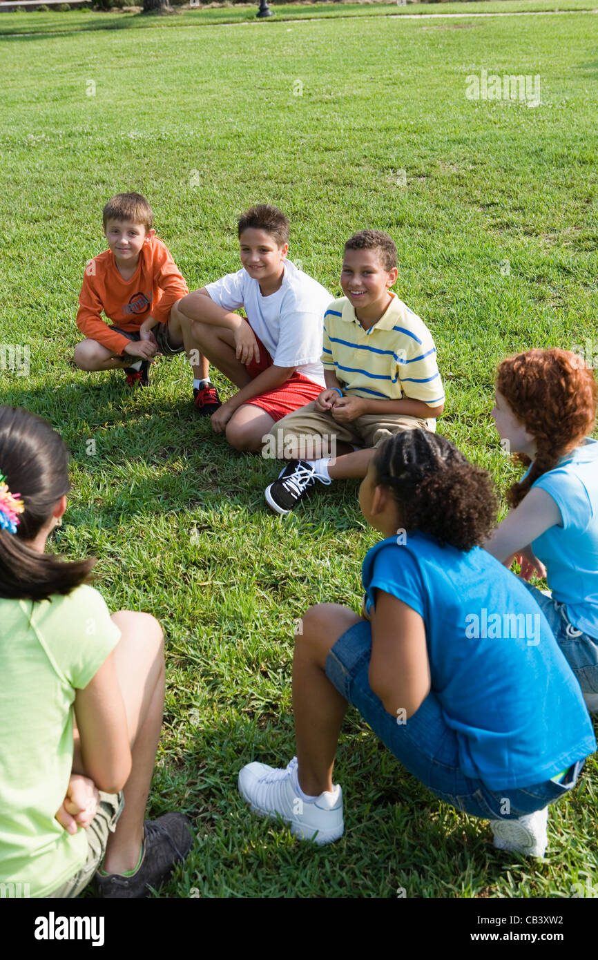 Group of children sitting on the grass Stock Photo - Alamy