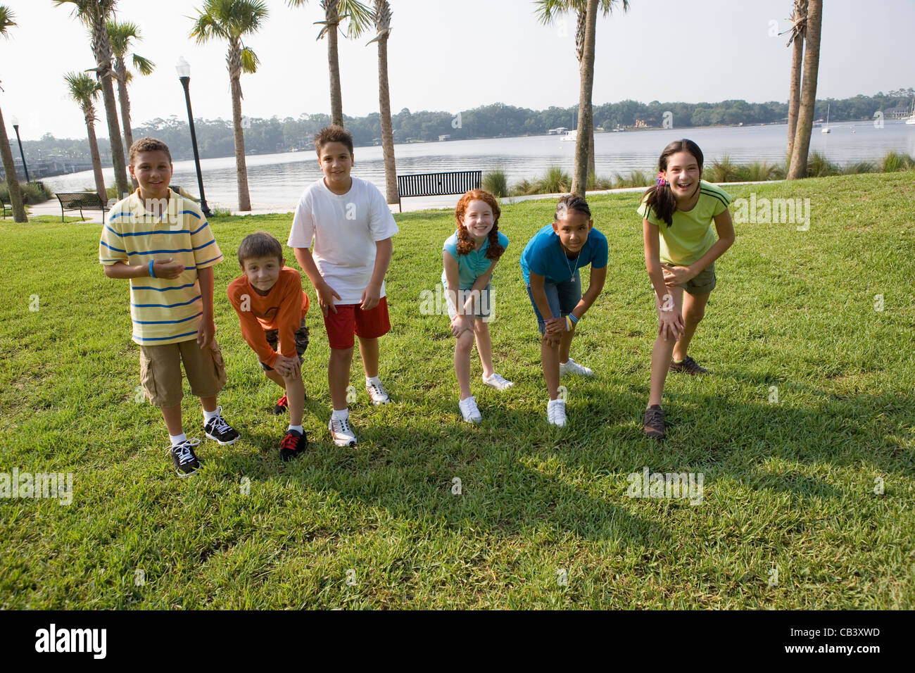 Children standing abreast at a park, getting set to race Stock Photo ...
