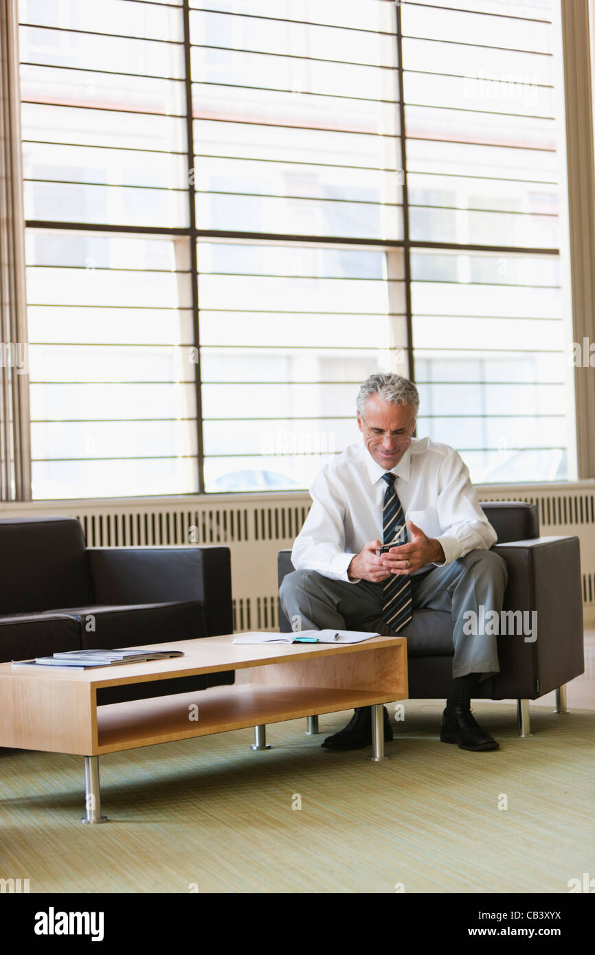 Business executive waiting in office lobby Stock Photo - Alamy