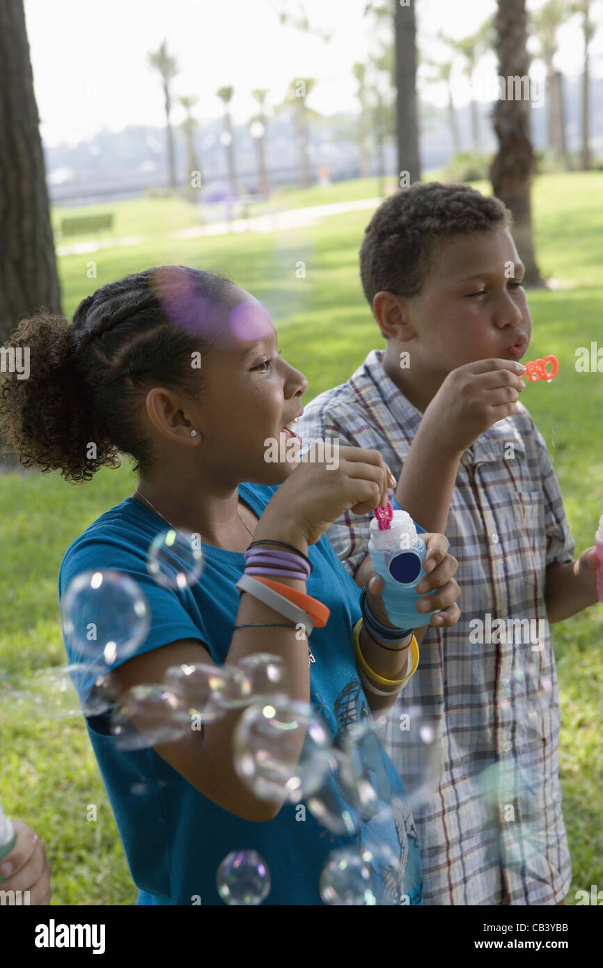 Children blowing bubbles at a park Stock Photo - Alamy