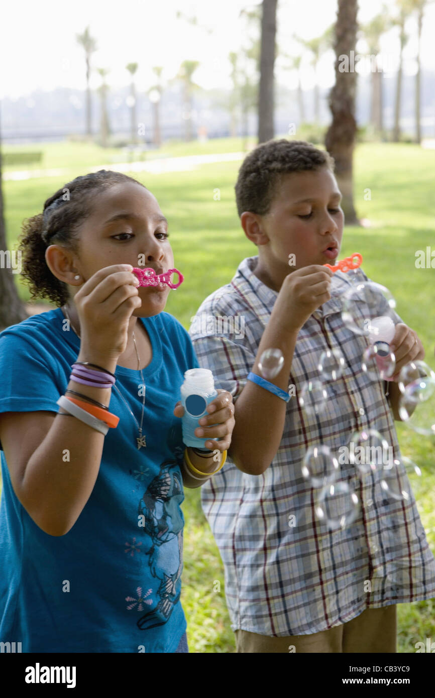 Children blowing bubbles at a park Stock Photo - Alamy