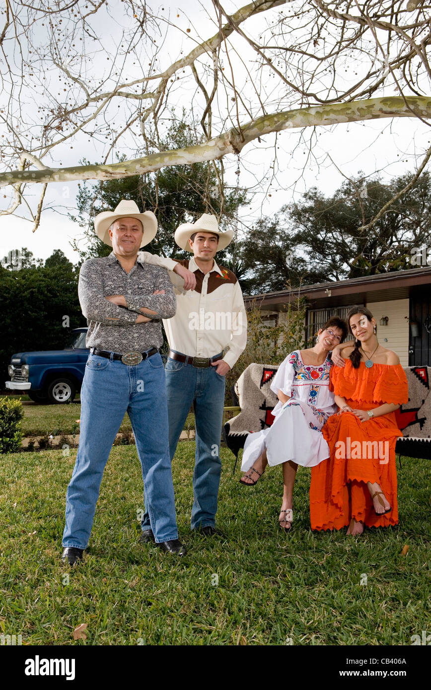 Portrait of a Tex-Mex family with adult children in front yard of house ...