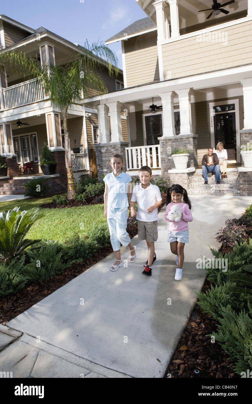 Children playing in lawn houses hi-res stock photography and images - Alamy