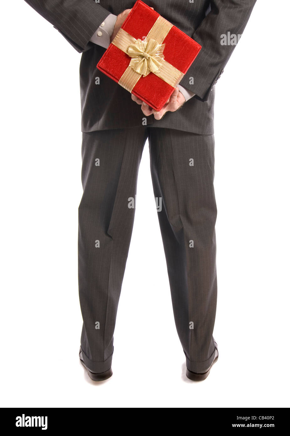 Man in suit hiding a surprise Christmas or Valentine's Day gift behind ...