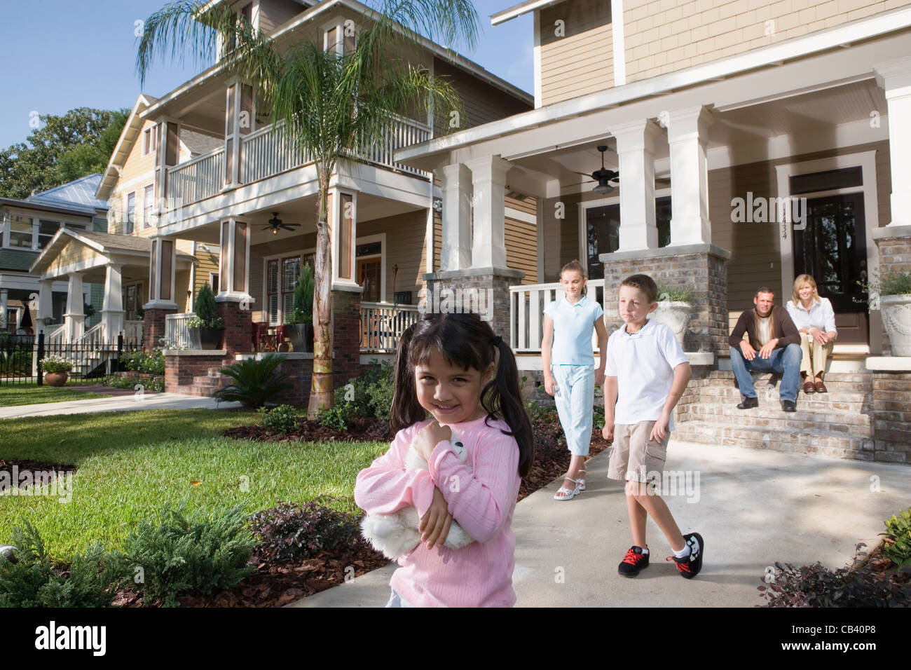 Children play parents watch hi-res stock photography and images - Alamy