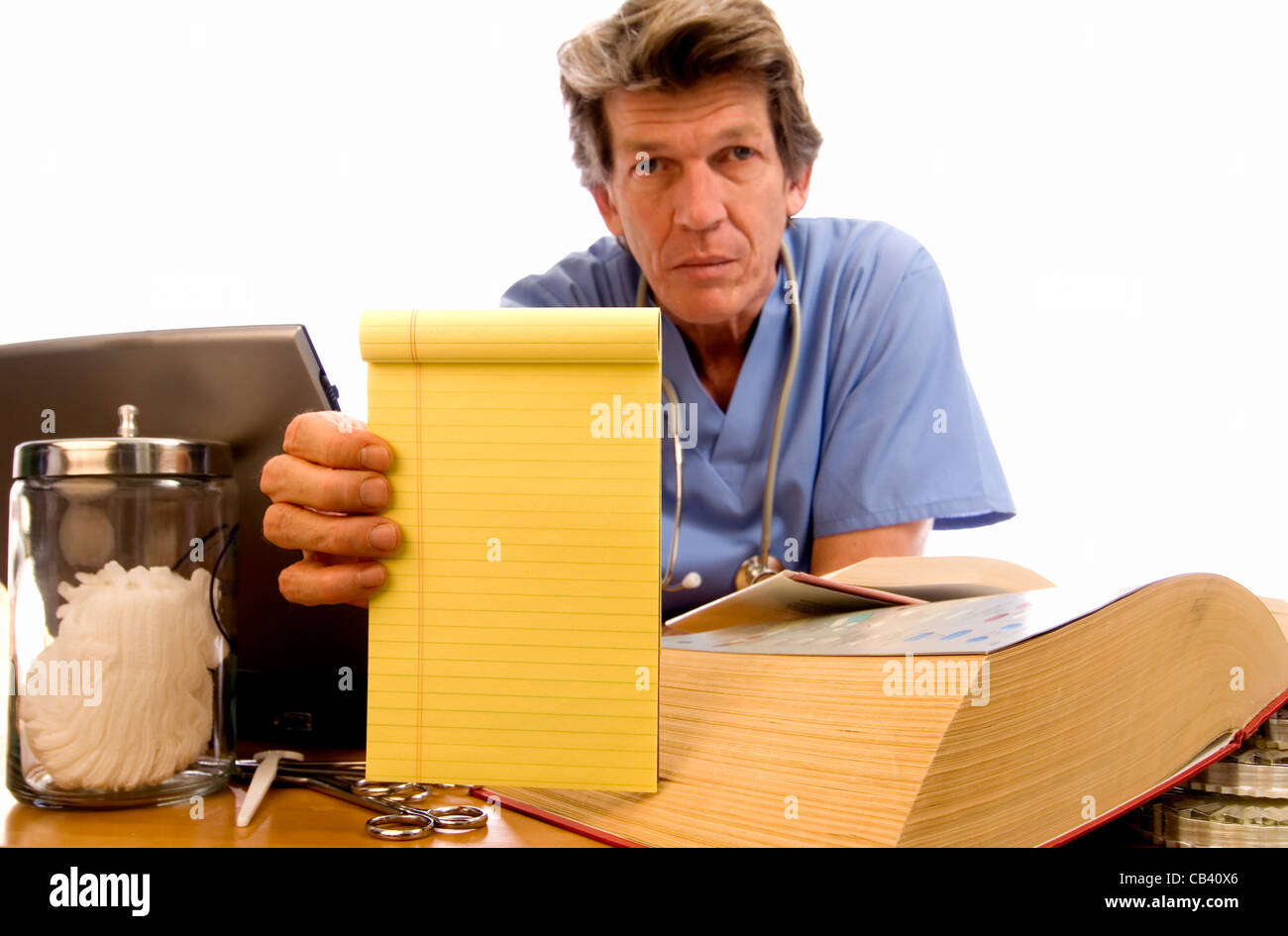 Doctor holding up a note pad to his patient. For your text Stock Photo ...