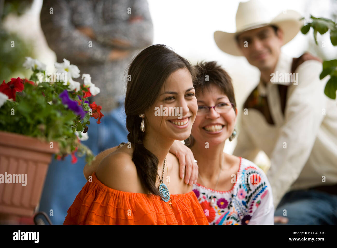 Portrait of a cheerful Tex-Mex family in front porch of house Stock ...