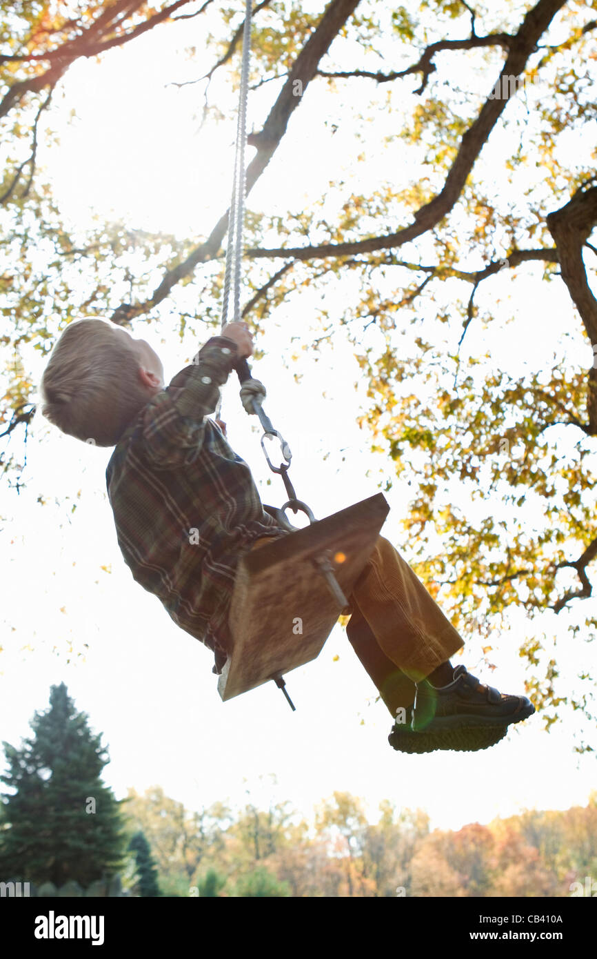 Boy on swing Stock Photo - Alamy