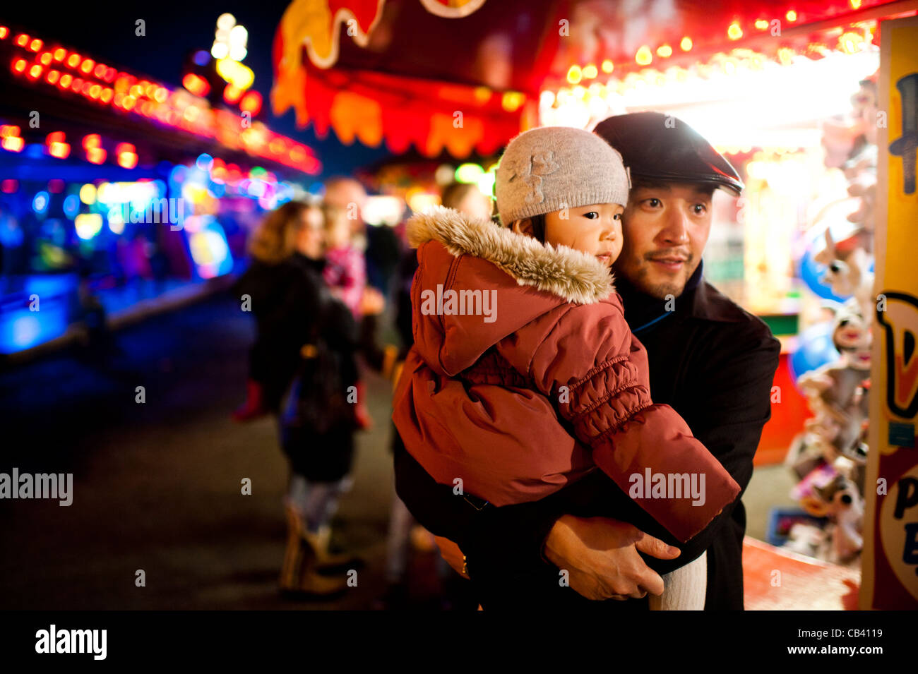 father daughter looking entranced at the lights and sounds of the Aberystwyth annual November ...