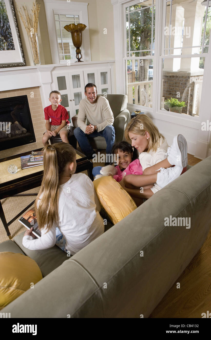 Family sitting together in the living room Stock Photo - Alamy