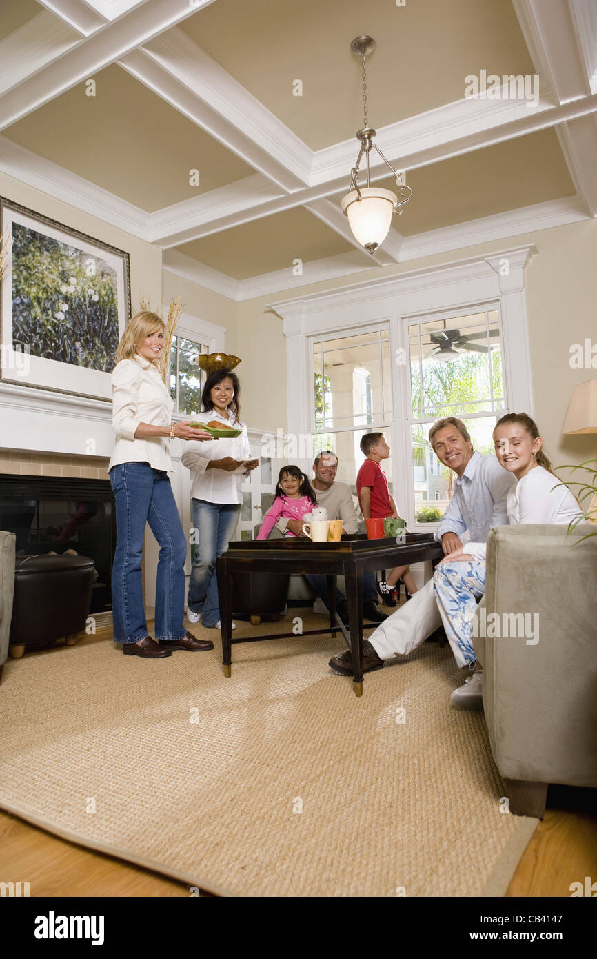 Family and friends together in living room Stock Photo - Alamy
