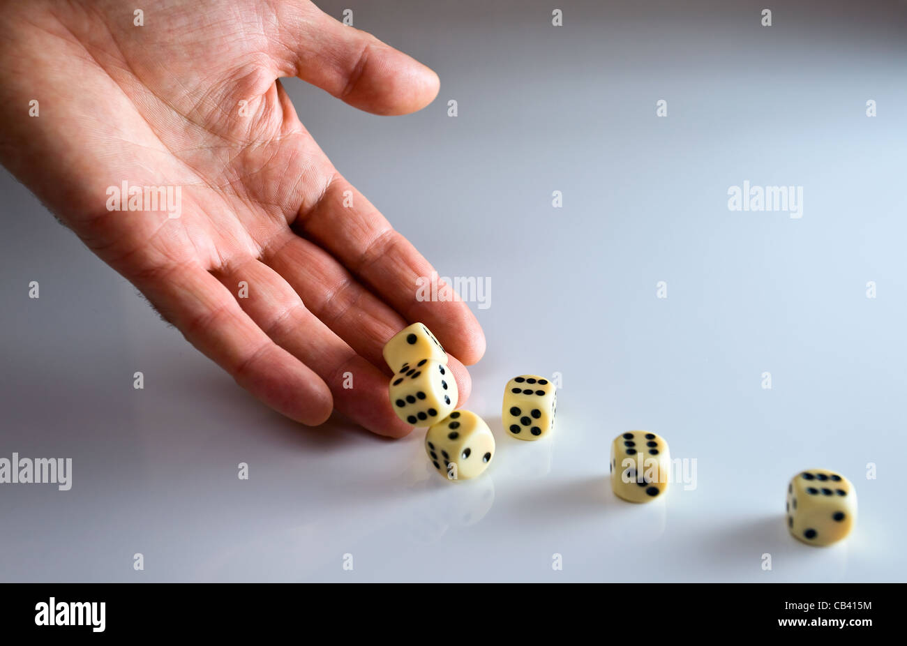 The hand of the person throwing cubes for dicing Stock Photo - Alamy