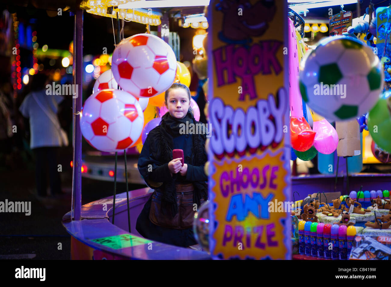 A young teenage girl working at the Aberystwyth annual November funfair ...