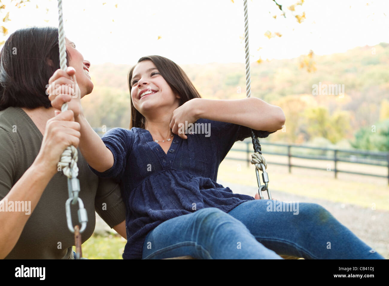 Mother with daughter on swing Stock Photo - Alamy