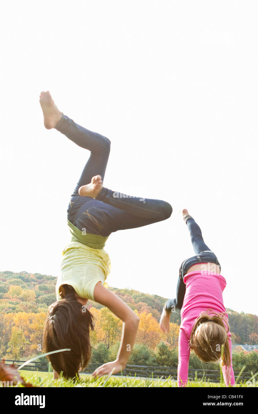 Two girls doing handstand in hi-res stock photography and images - Alamy