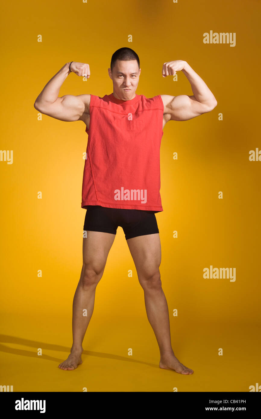 Athlete flexing muscles Stock Photo - Alamy