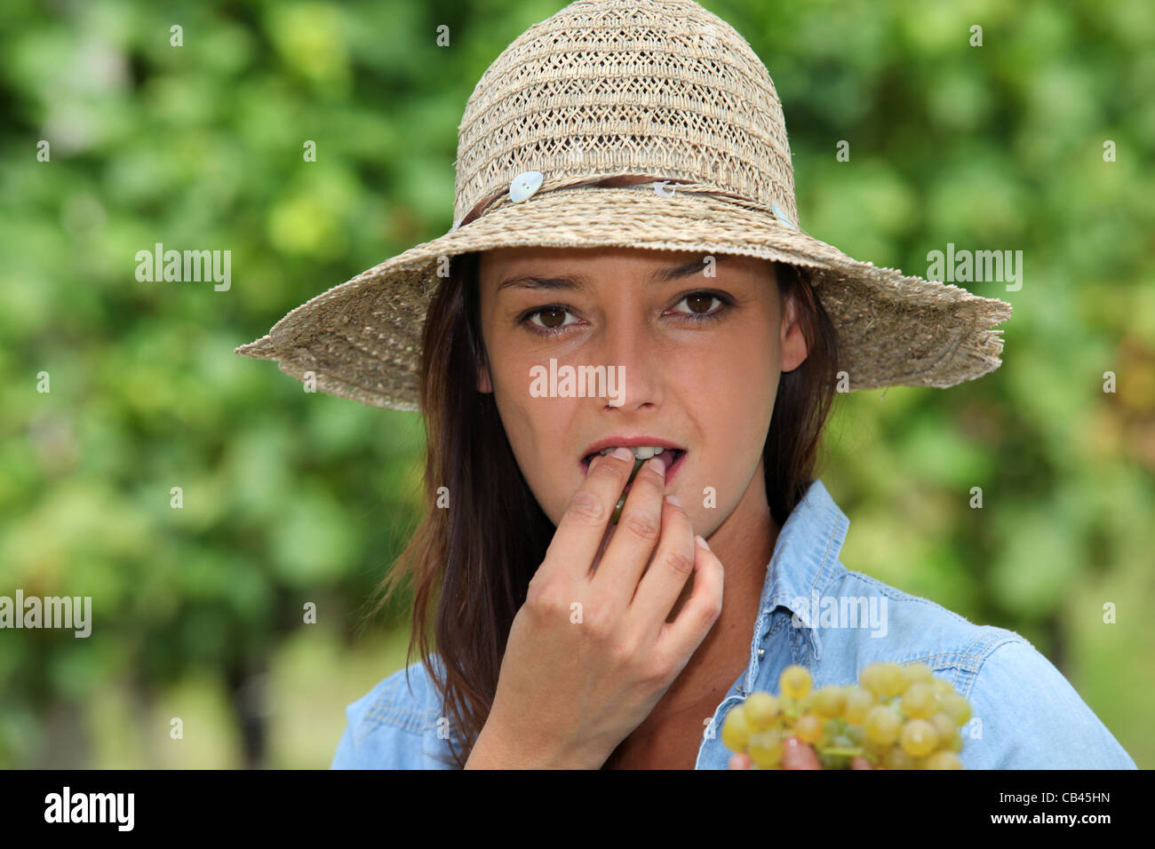 young woman eating grapes Stock Photo - Alamy