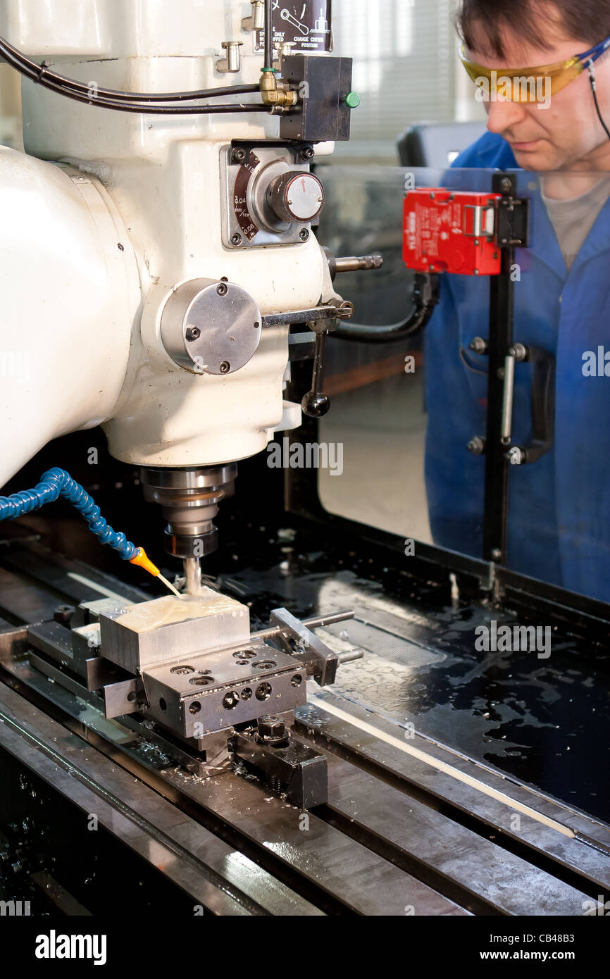 Engineering technician, Engineer working a CNC milling machine with ...