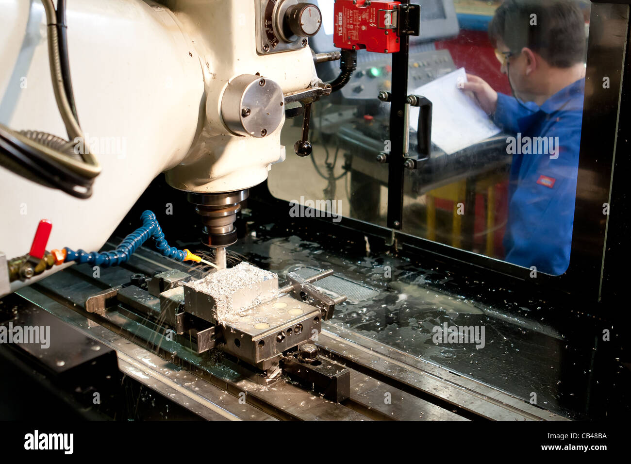 Engineering technician, Engineer working a CNC milling machine with ...