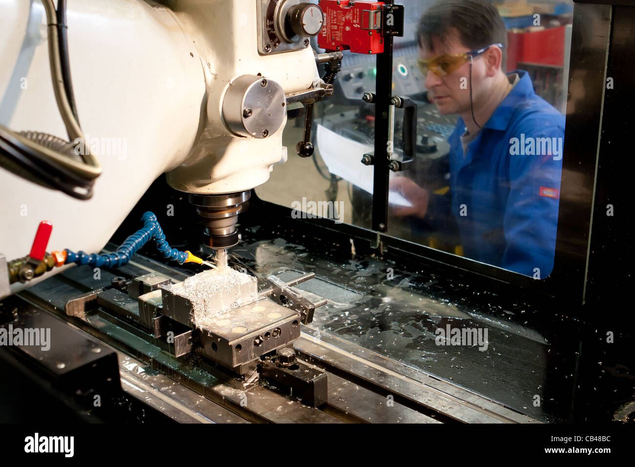 Engineering technician, Engineer working a CNC milling machine with ...