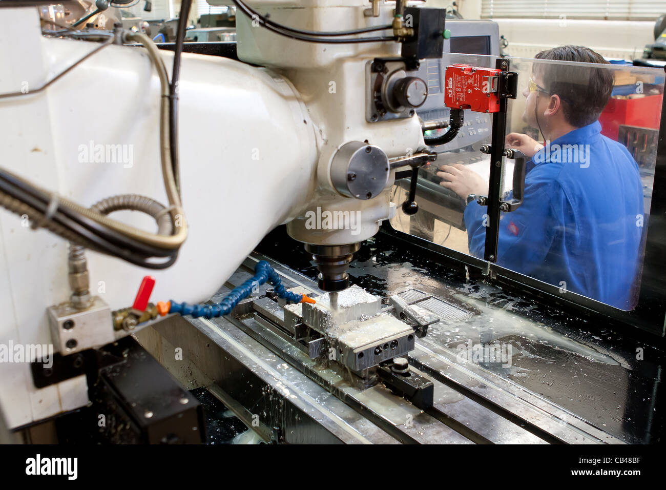 Engineering technician, Engineer working a CNC milling machine with ...