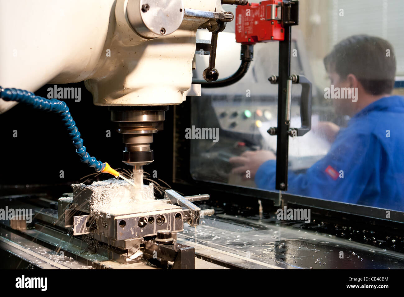 Engineering technician, Engineer working a CNC milling machine with ...