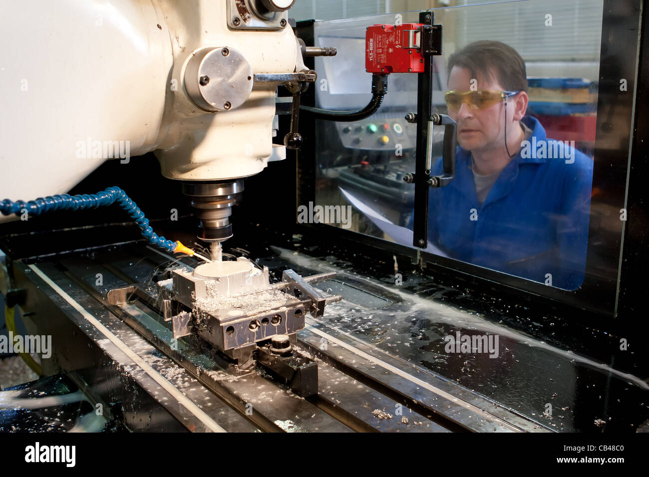 Engineering technician, Engineer working a CNC milling machine with ...