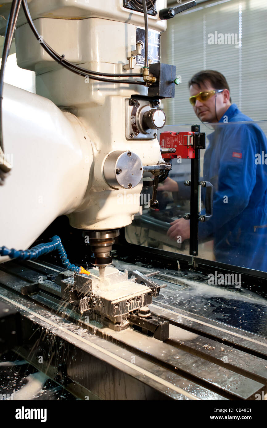 Engineering technician, Engineer working a CNC milling machine with ...