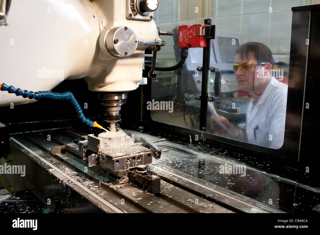 Engineering technician, Engineer working a CNC milling machine with ...