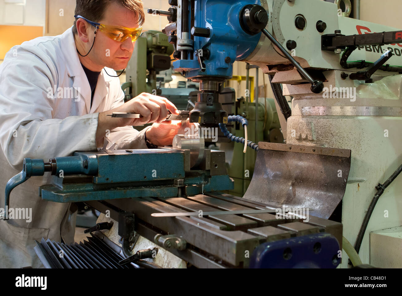 Engineering technician, Engineer working a milling machine with ...