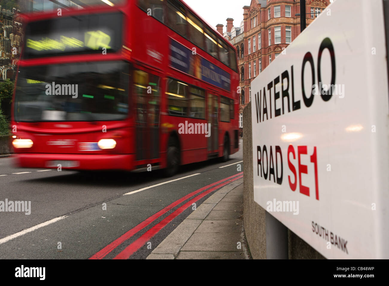 a close up of a ' Waterloo Road' road sign with a red London double ...