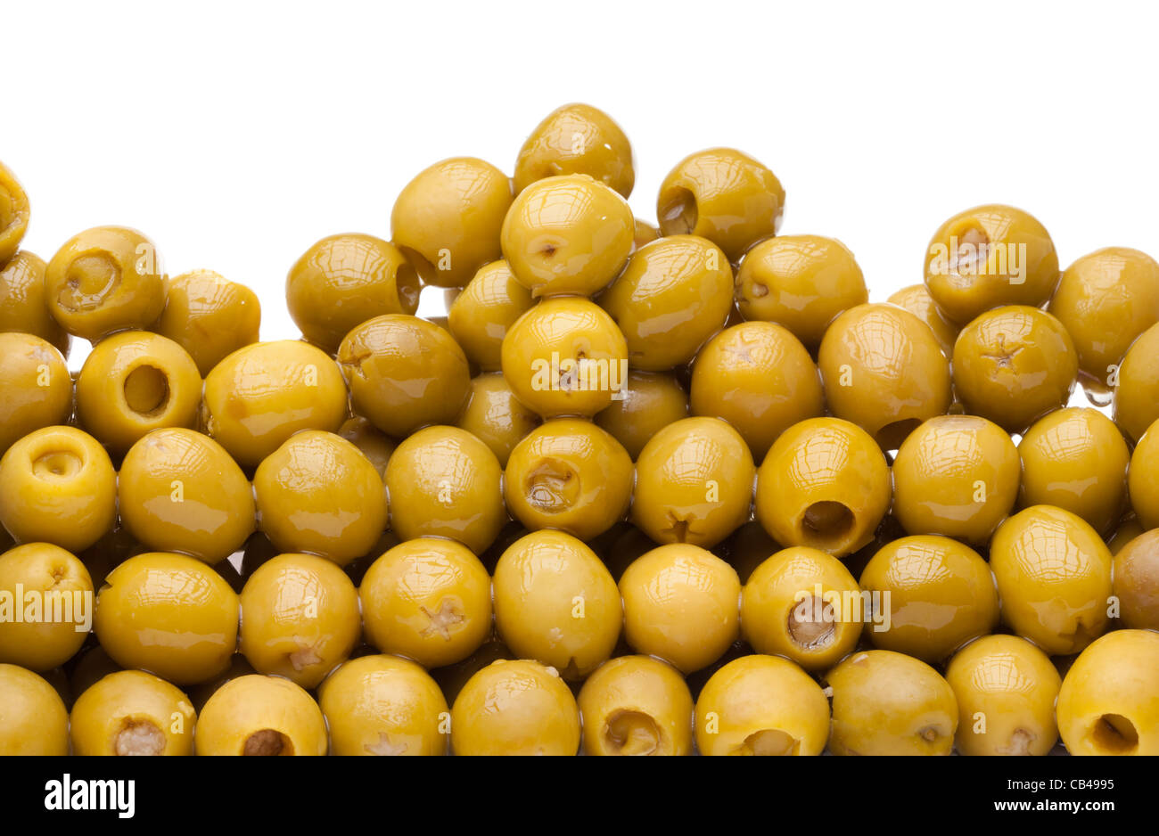 A lot of olives in a pile, isolated on white background Stock Photo - Alamy